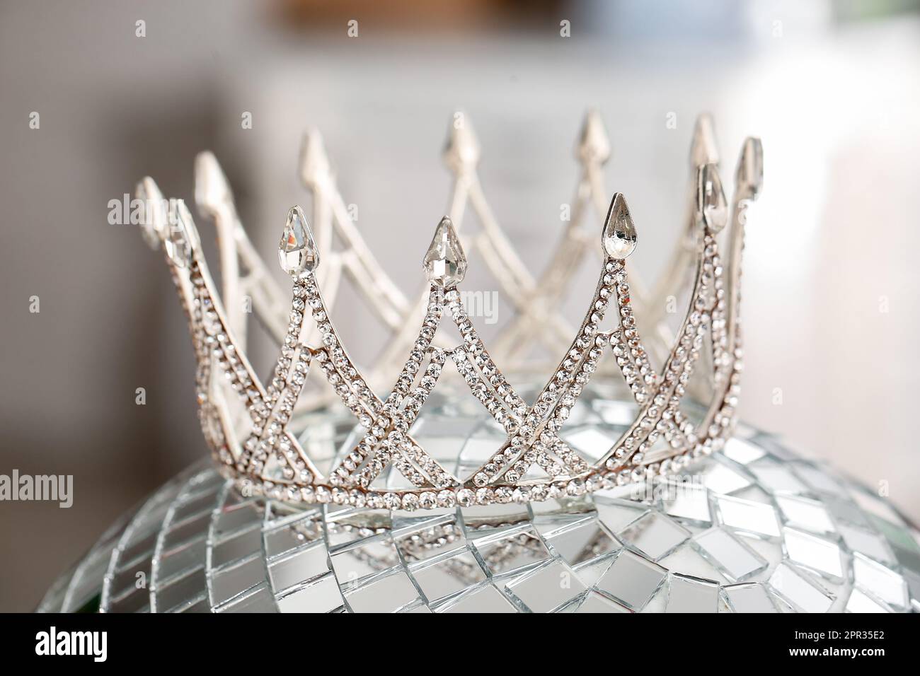 Beautiful crown on disco ball, closeup. Prom concept Stock Photo - Alamy