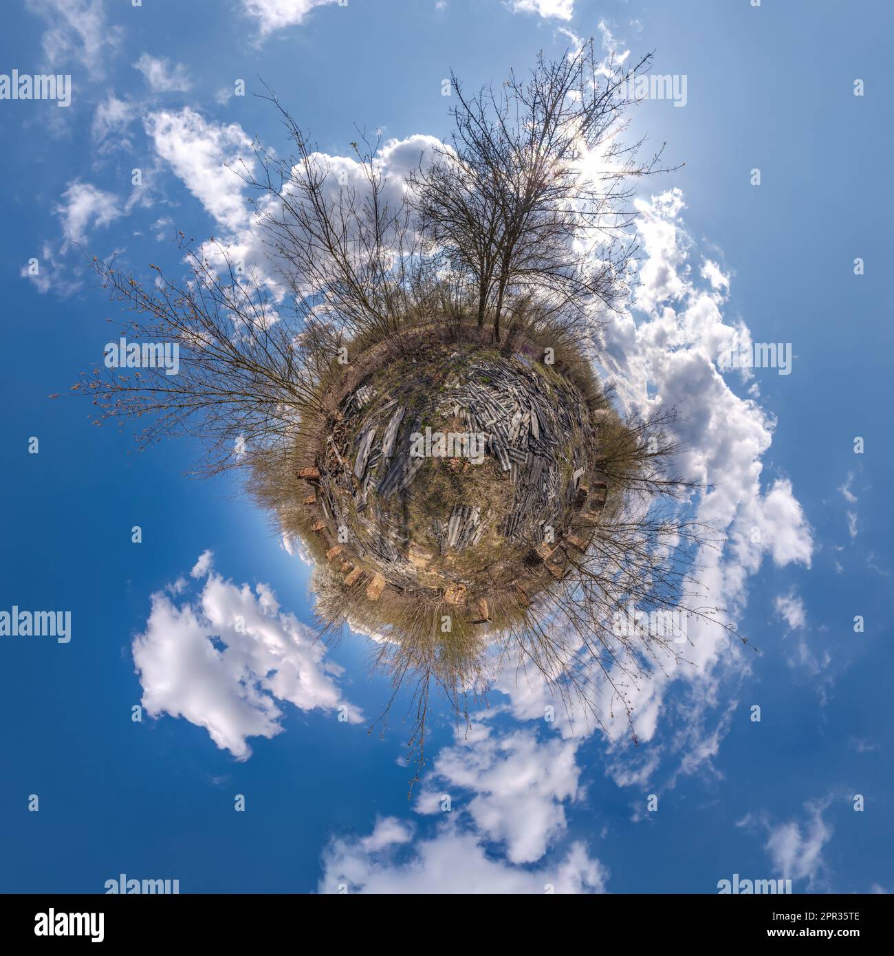 green tiny planet in blue sky with beautiful clouds with transformation ...