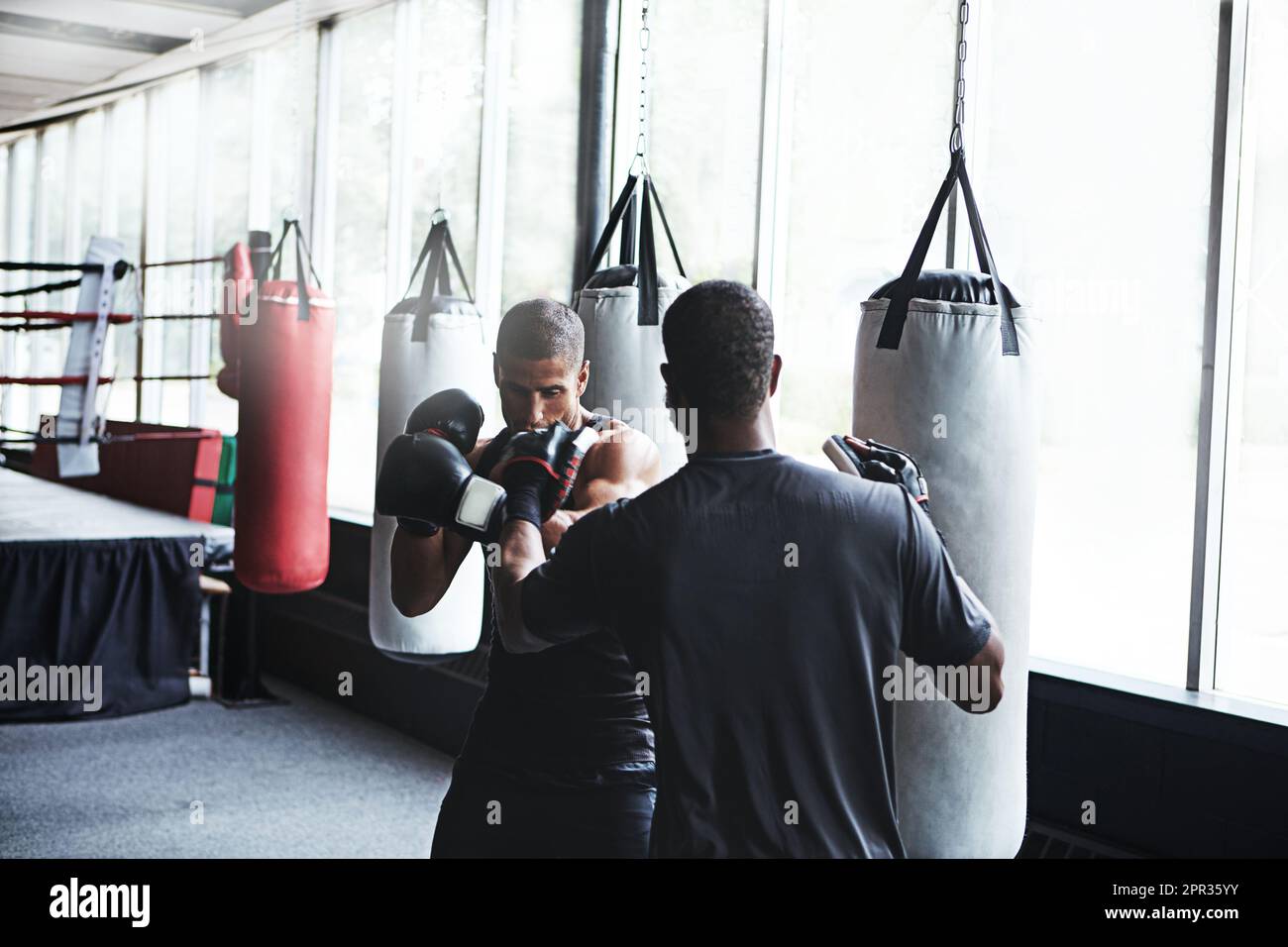 Preparing to be the greatest. a male boxer practising his moves with ...