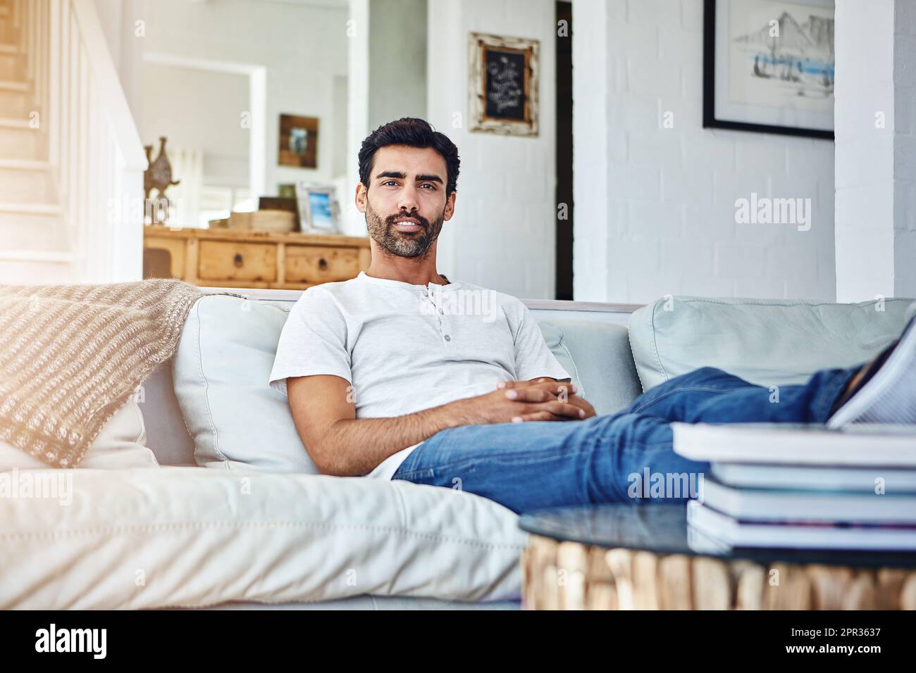 This is what relaxing weekends look like. a man relaxing on the sofa at ...