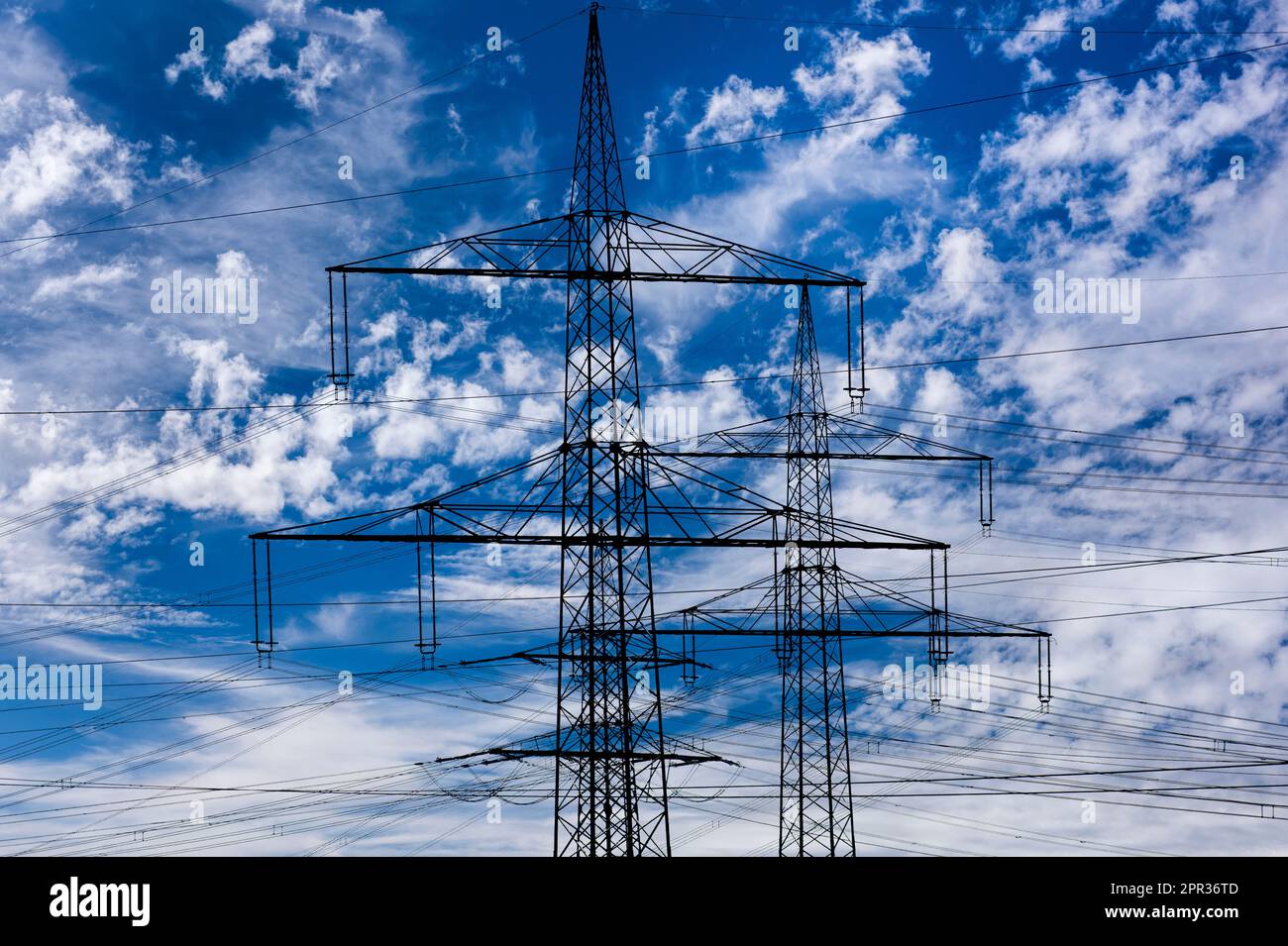 high voltage electric pylons against sky with dramatic clouds Stock ...