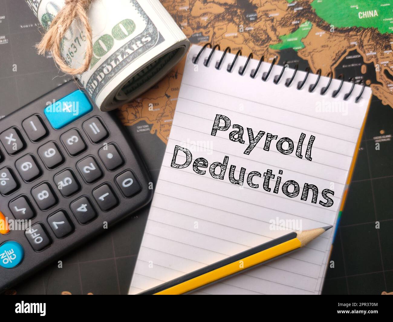 Calculator,pencil and banknotes with the word Payroll Deduction on ...