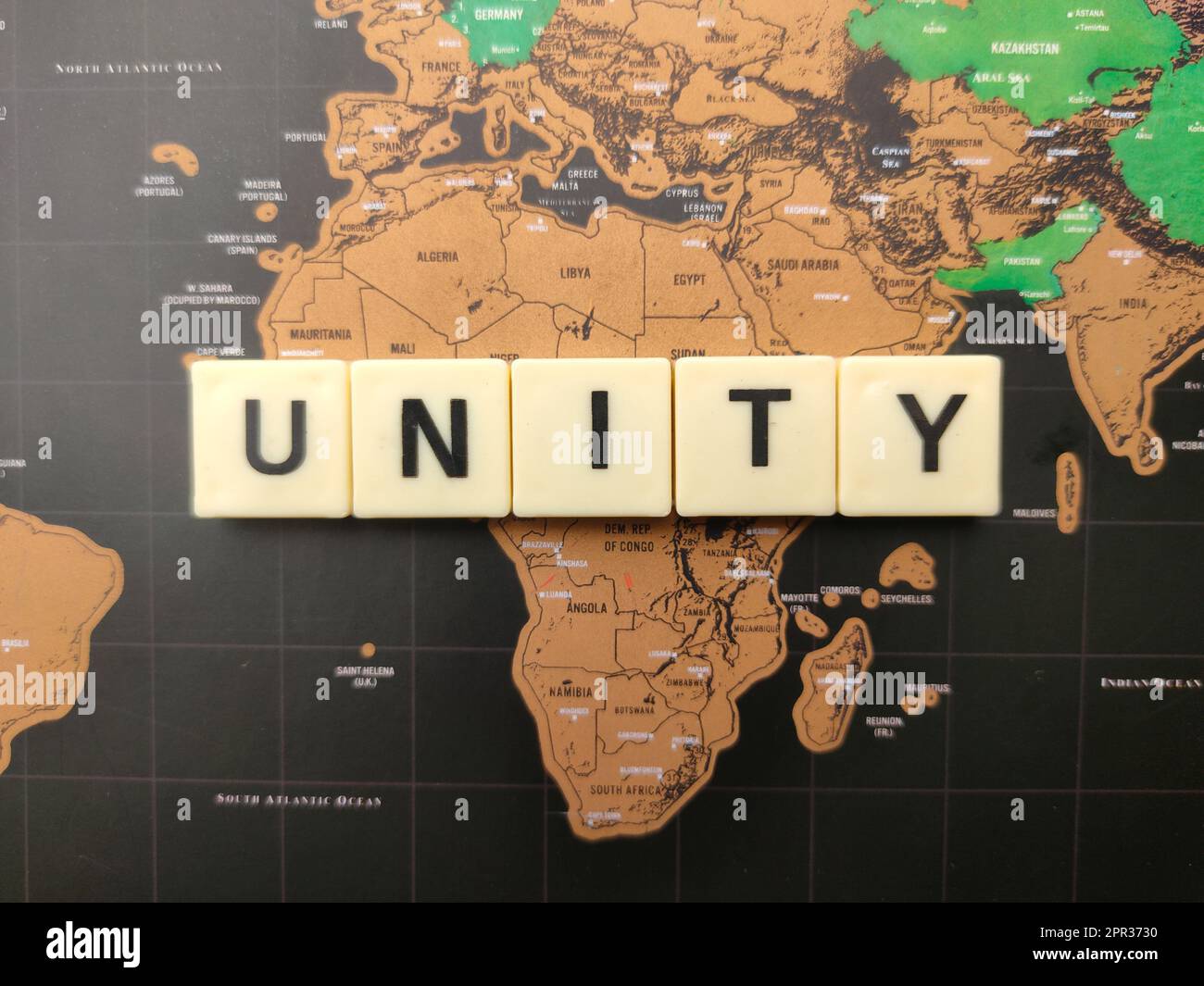 Top view toys word with the word UNITY on a world map background Stock ...
