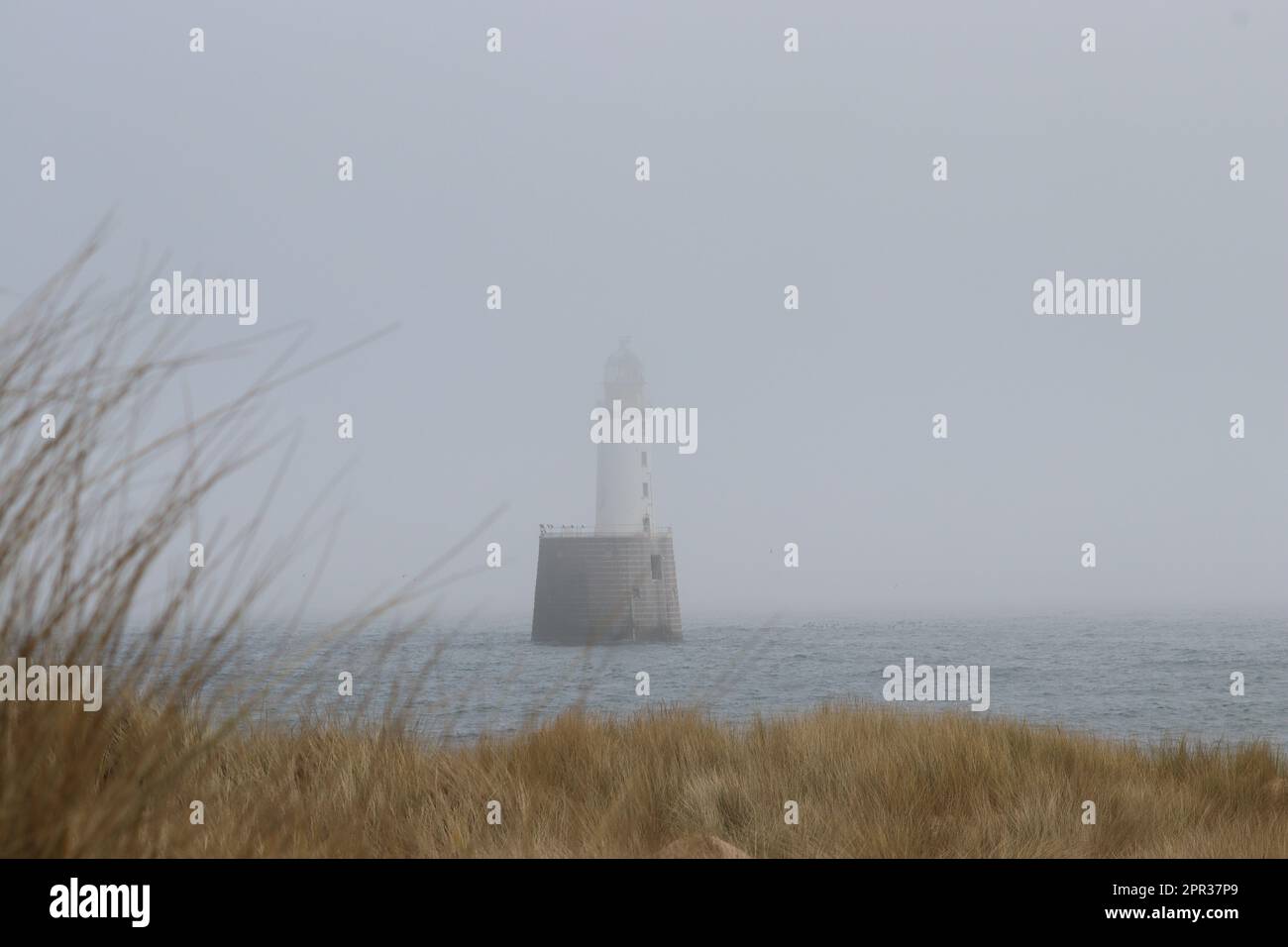 White lighthouse in mist Stock Photo - Alamy