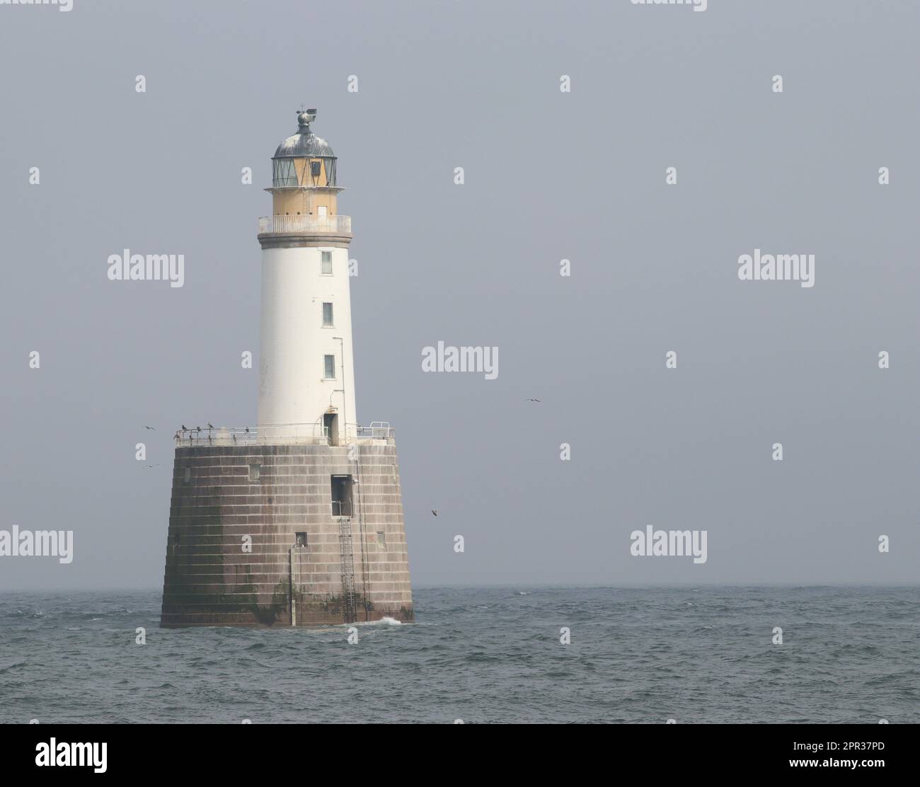 White lighthouse in mist Stock Photo - Alamy
