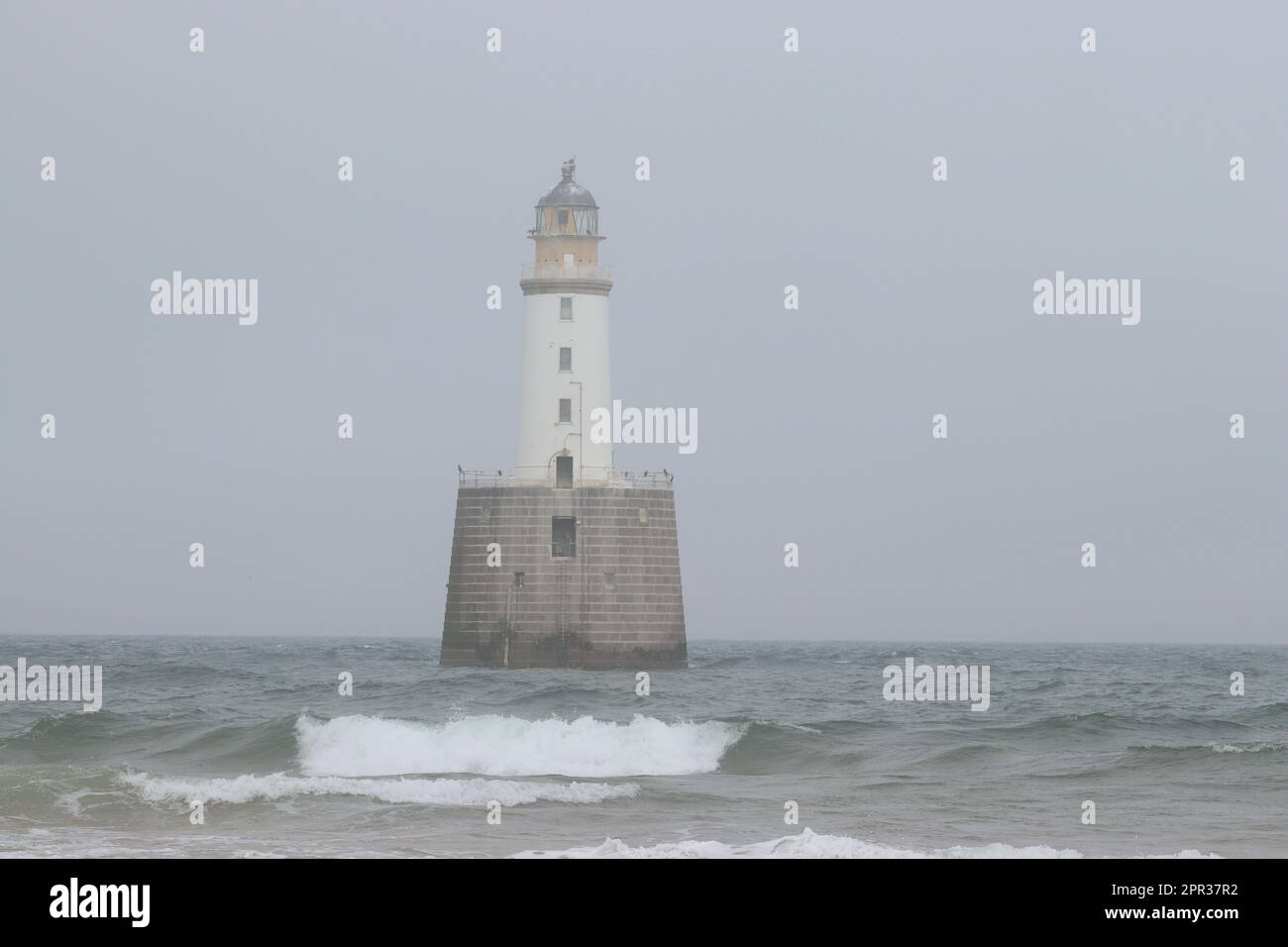 White lighthouse in mist Stock Photo - Alamy