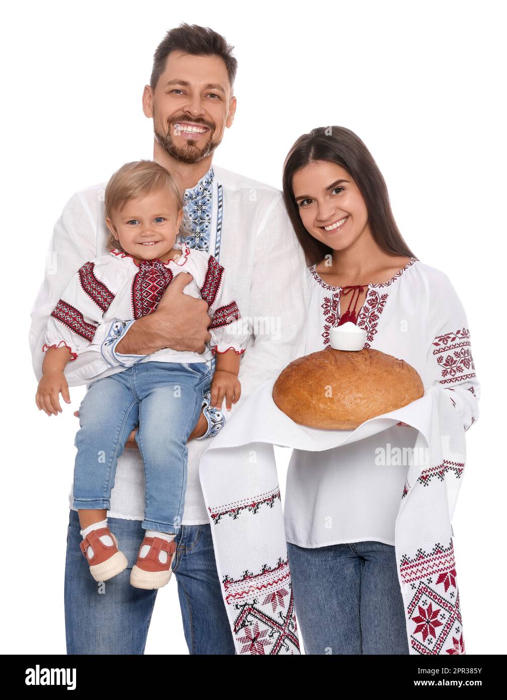 Happy Ukrainian family in embroidered shirts with korovai bread on ...