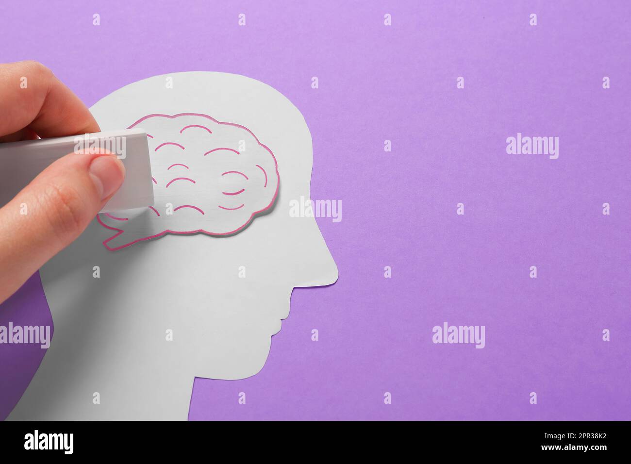 Woman erasing brain on human head paper cutout on violet background ...