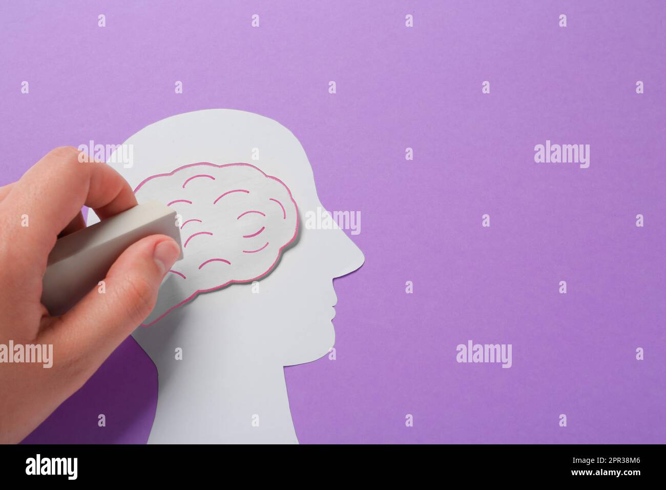 Woman erasing brain on human head paper cutout on violet background ...