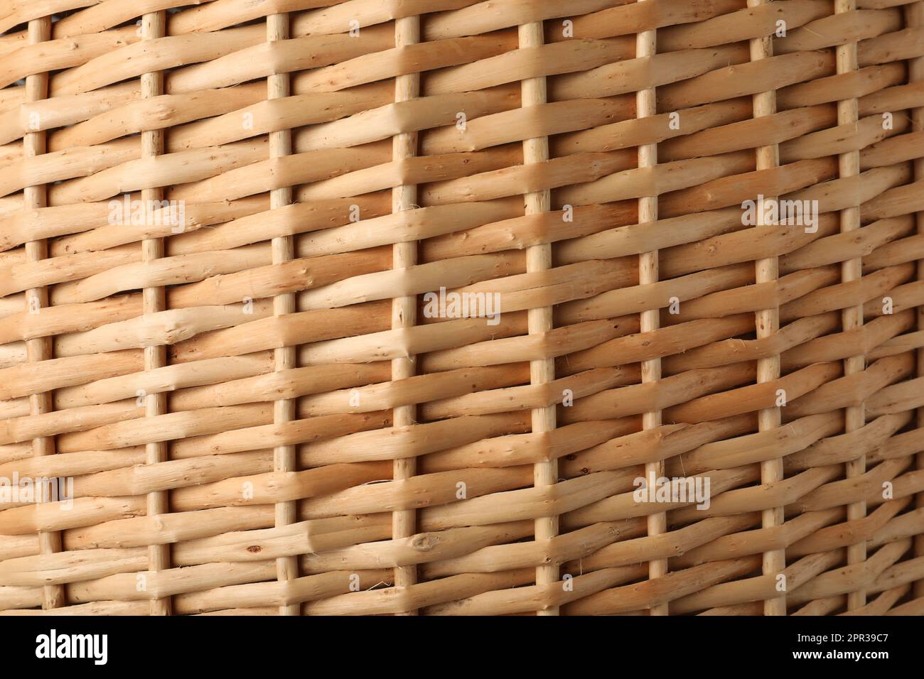 Handmade wicker basket made of natural material as background, closeup ...