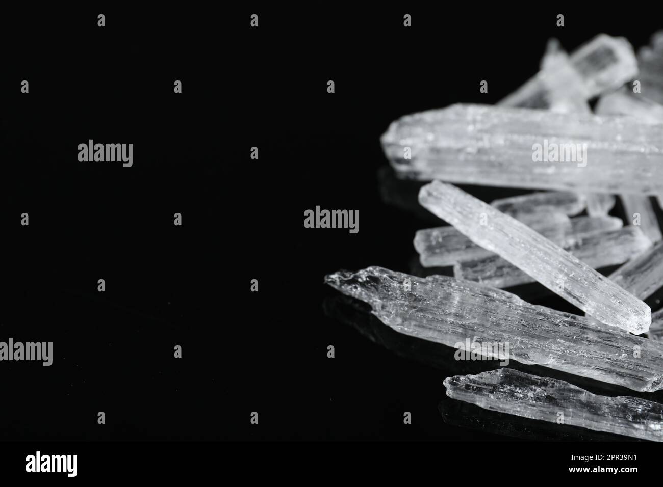 Menthol crystals on black background, closeup. Space for text Stock ...