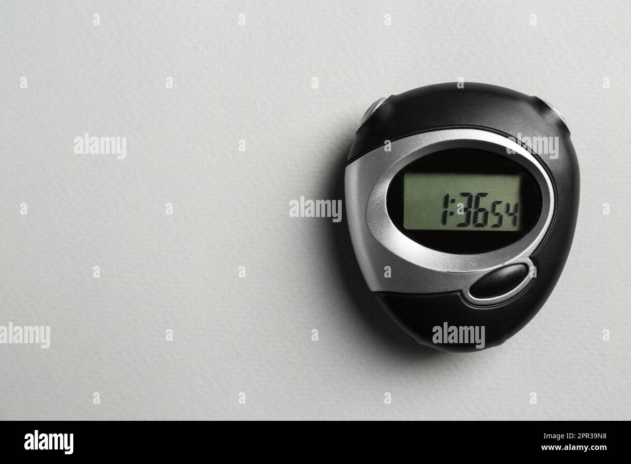 Digital timer on light grey background, top view. Space for text Stock ...