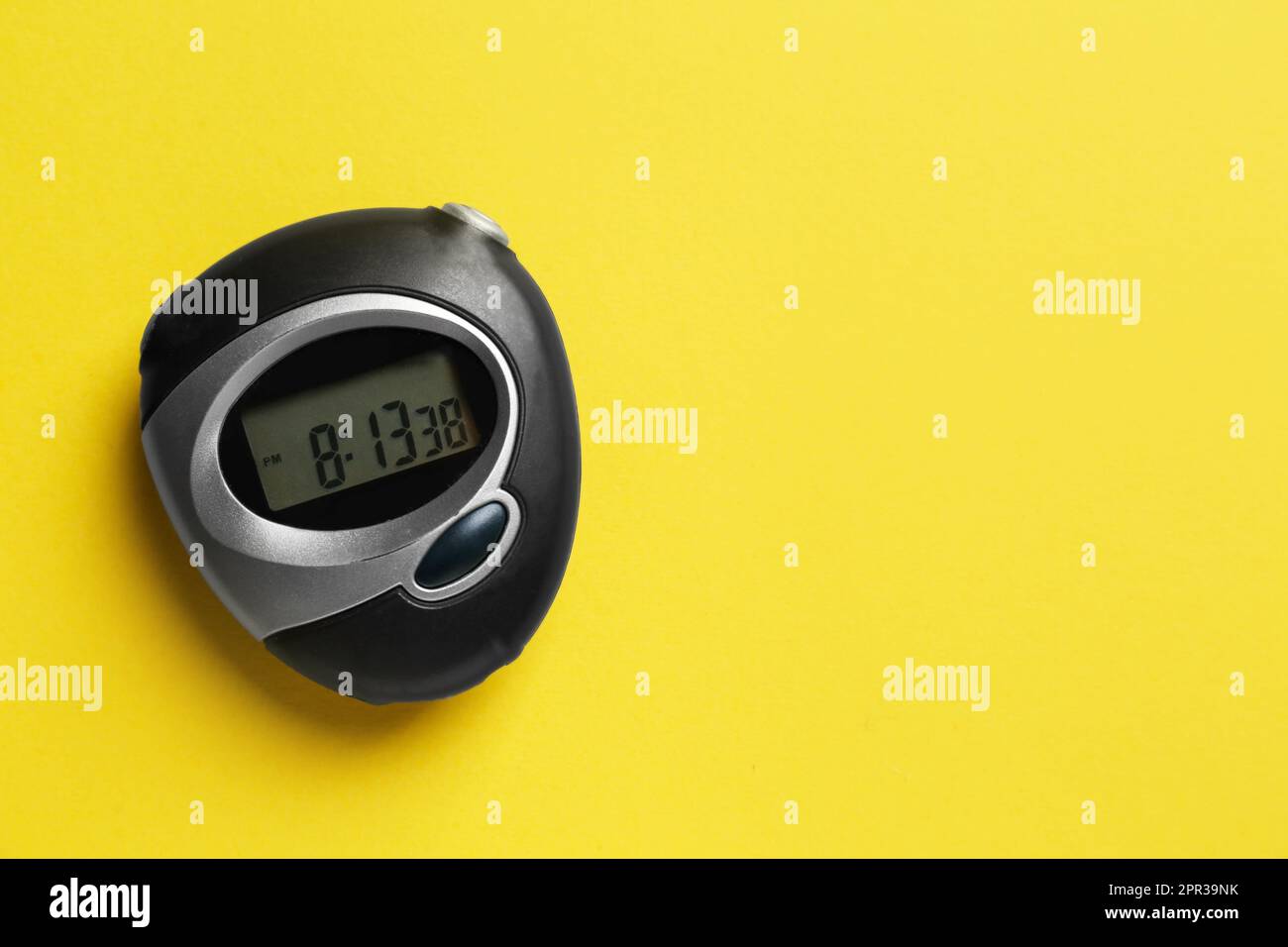 Digital timer on yellow background, top view. Space for text Stock ...