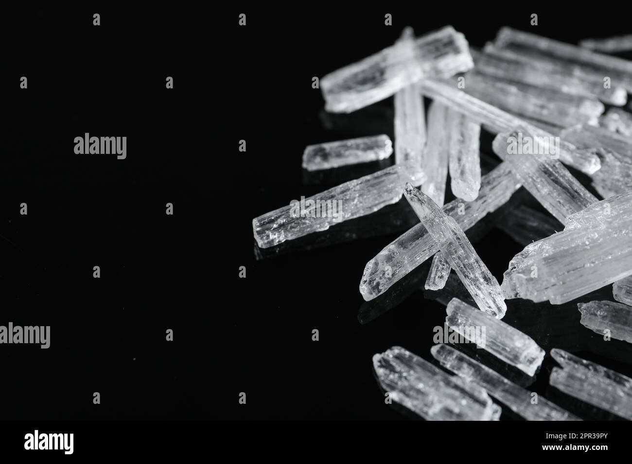 Menthol crystals on black background, closeup. Space for text Stock ...