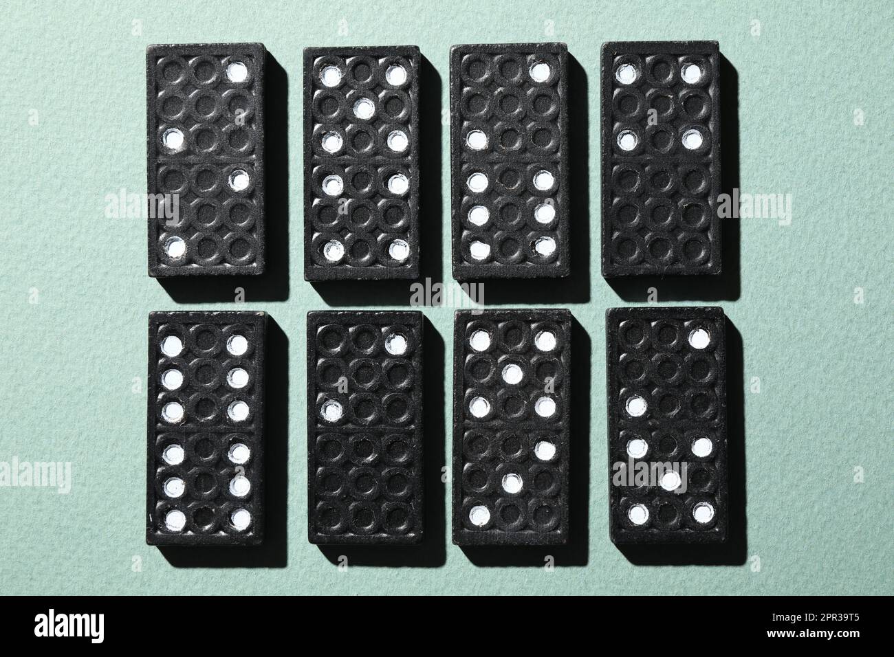 Set of black domino tiles on light green background, flat lay Stock ...