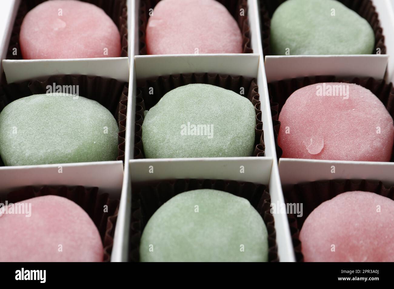Box with different delicious mochi as background, closeup. Traditional ...