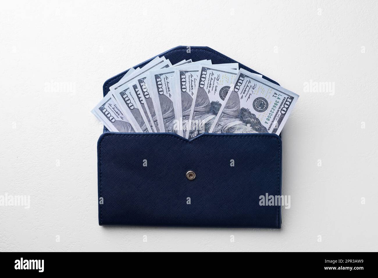 Dollar banknotes in wallet on white table, top view. Money exchange ...