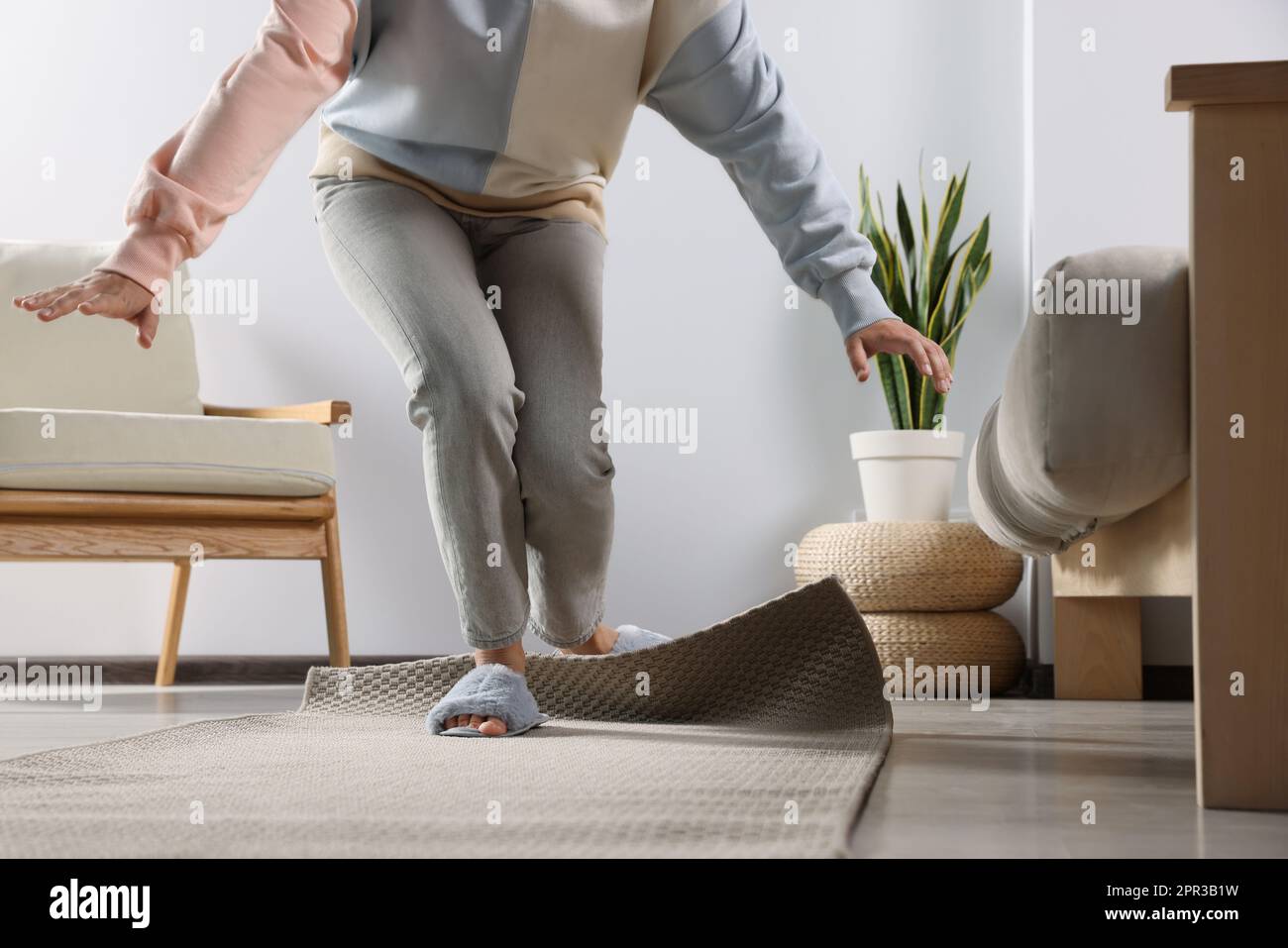 Woman tripping over carpet at home, closeup Stock Photo - Alamy