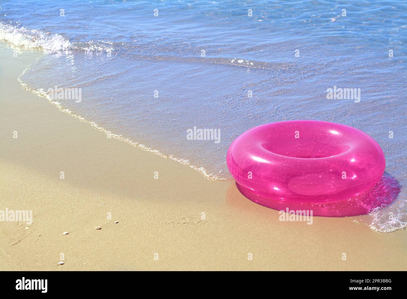 Bright inflatable ring on sandy beach near sea. Space for text Stock ...