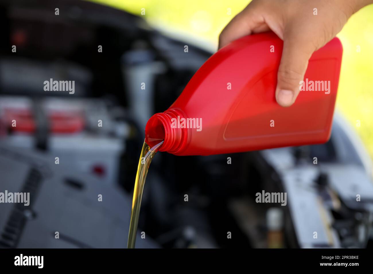 Man pouring oil into engine hi-res stock photography and images - Alamy