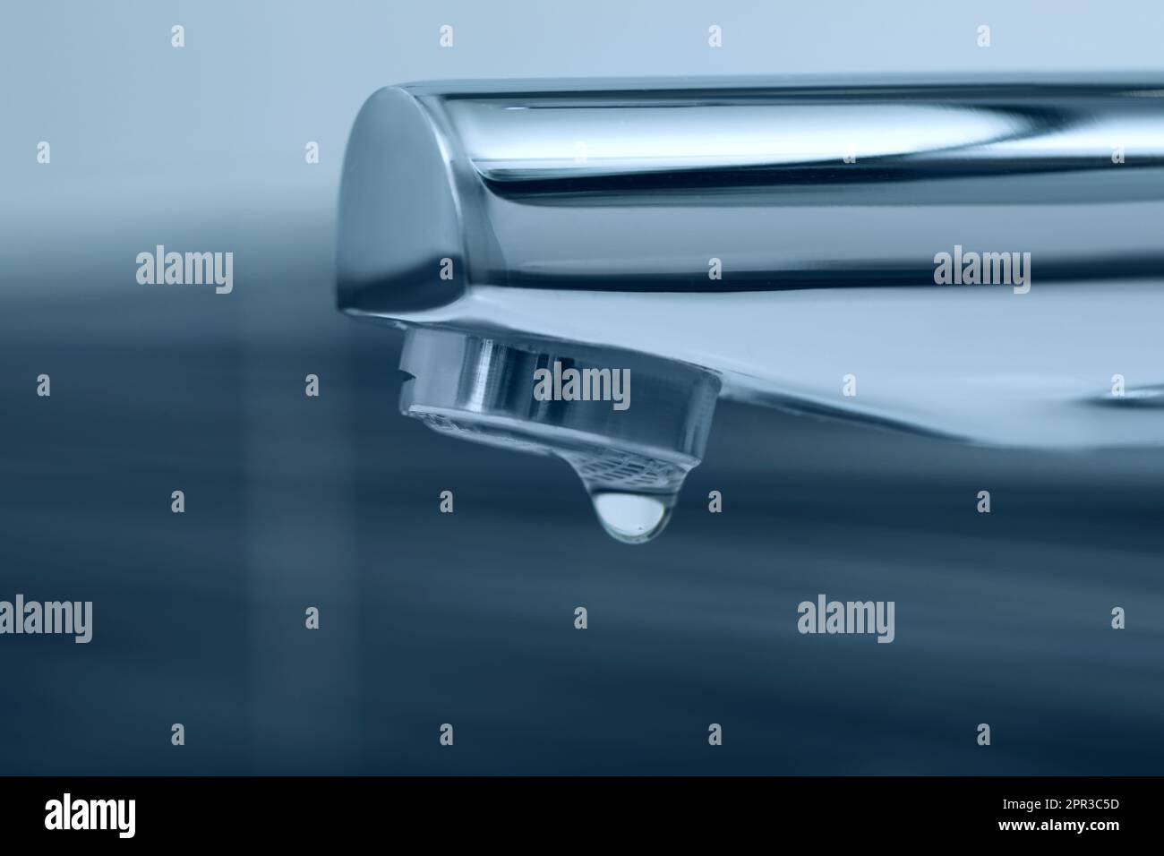 Water drop falling down from tap on blurred background, closeup Stock ...
