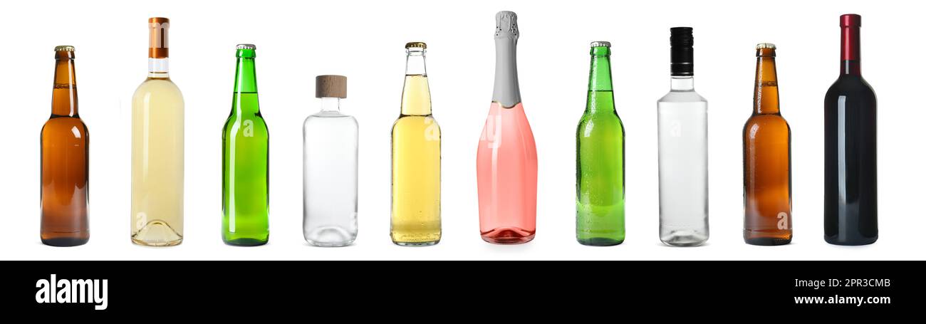 Set with bottles of different alcohol drinks on white background ...