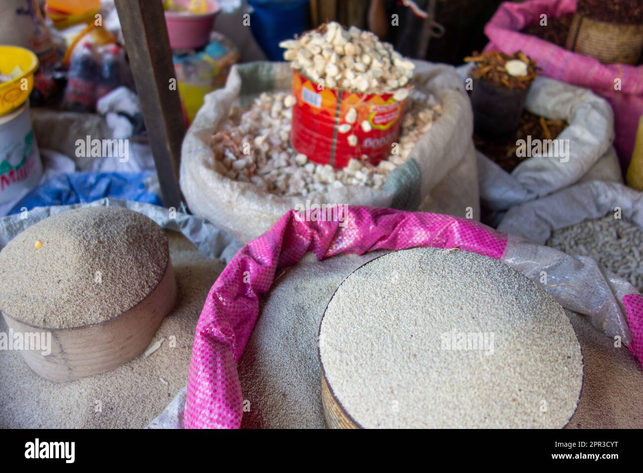 rice in sacks with measuring tins for sale in the market in West Africa ...