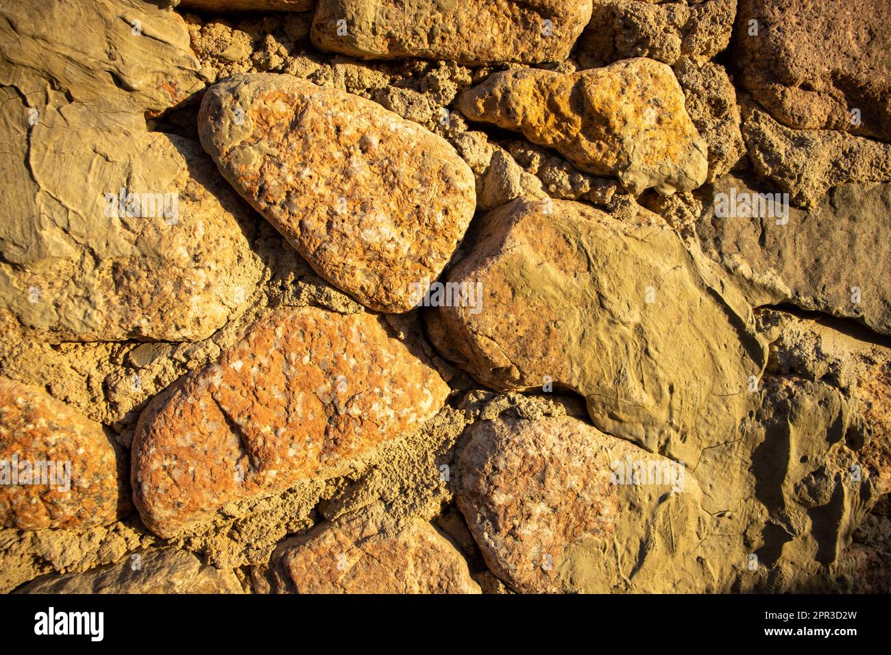 rocks and cement making a wall texture Stock Photo - Alamy