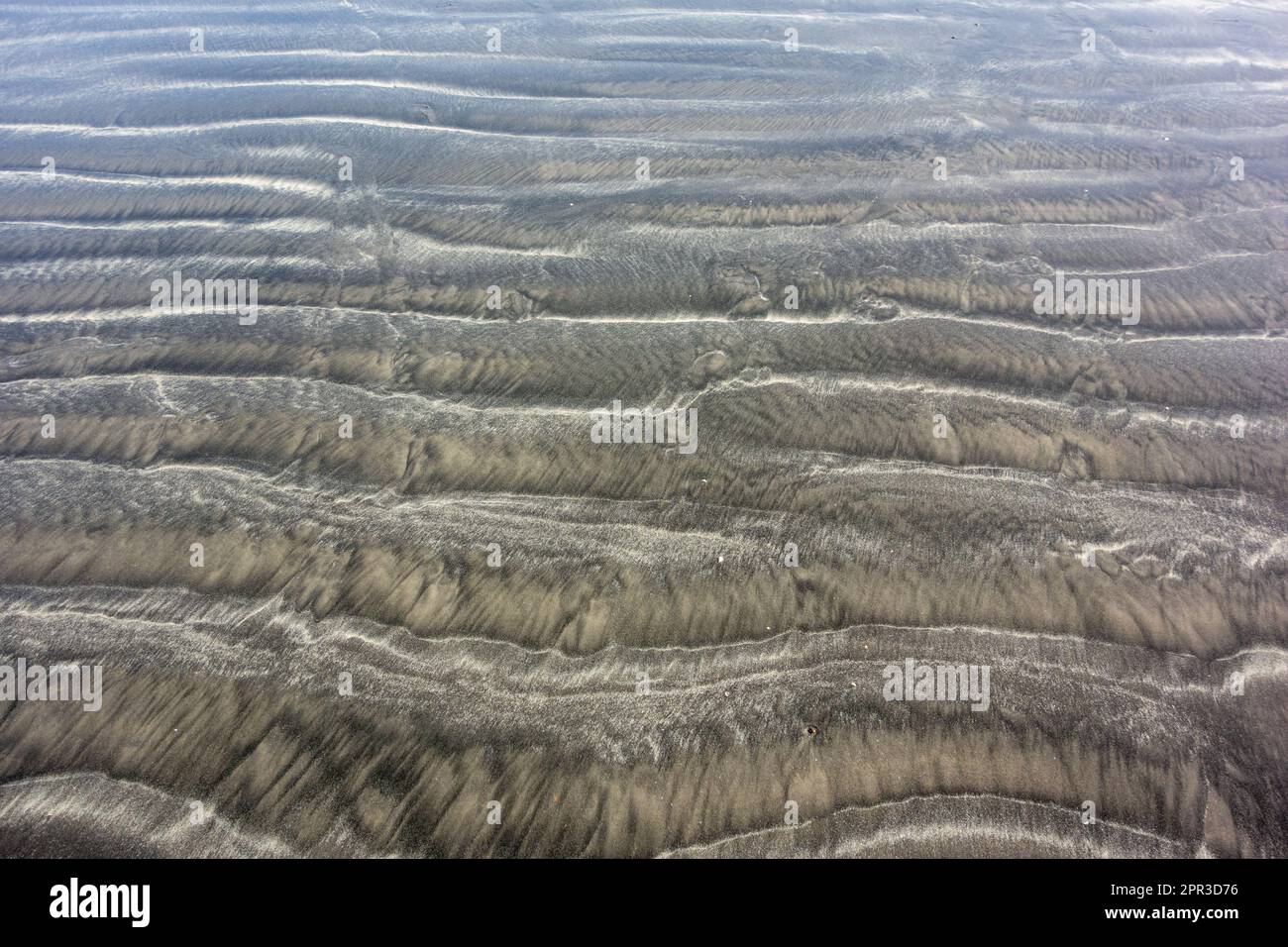 sand patterns made when the wave goes out and in on the beach Stock ...