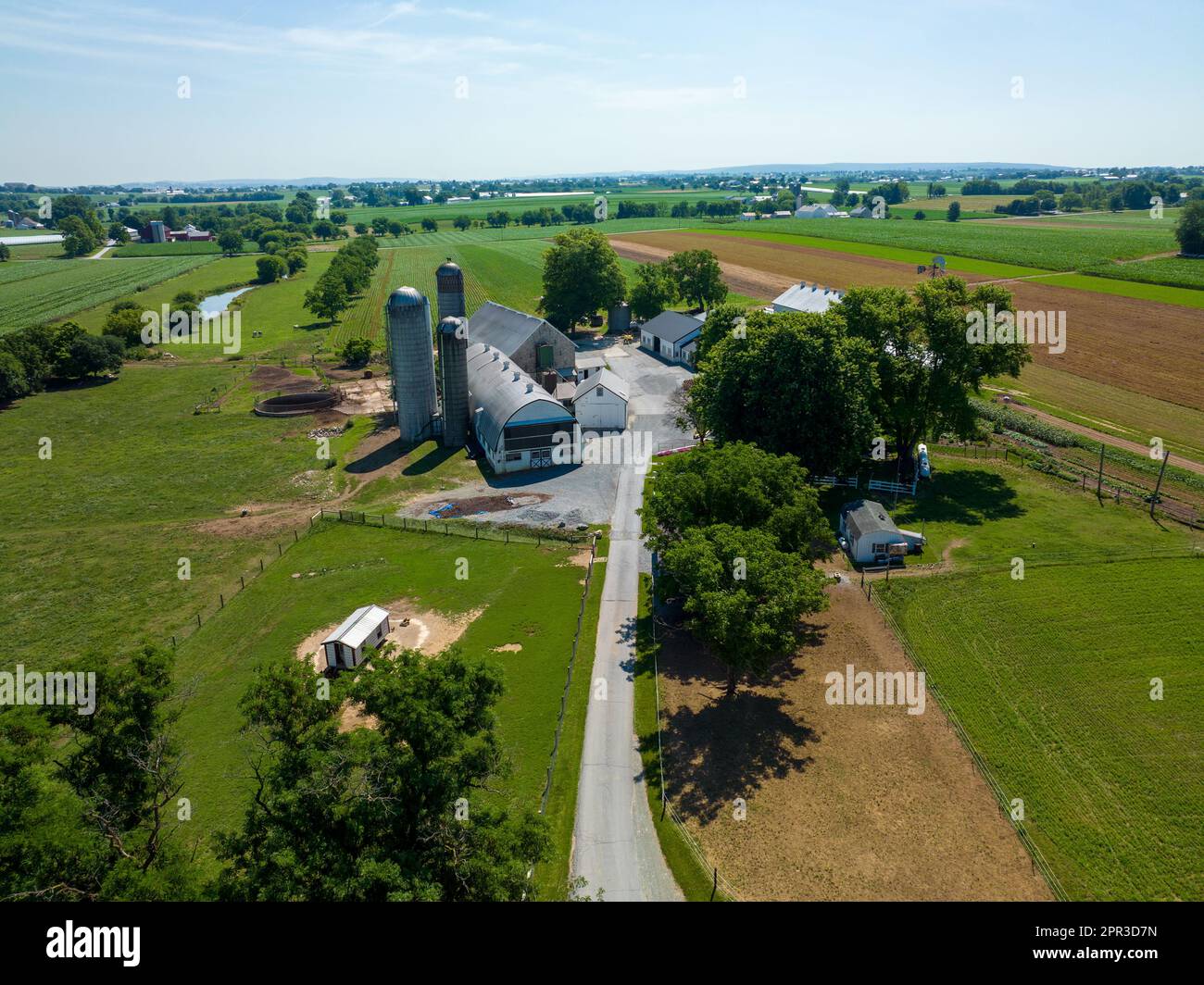 An aerial view of a farm surrounded by the lush green fields in Lancaster County, Pennsylvania ...