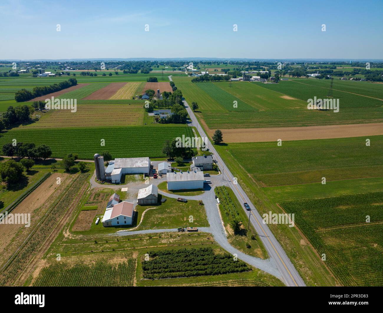 An aerial view of a farm surrounded by the lush green fields in Lancaster County, Pennsylvania ...