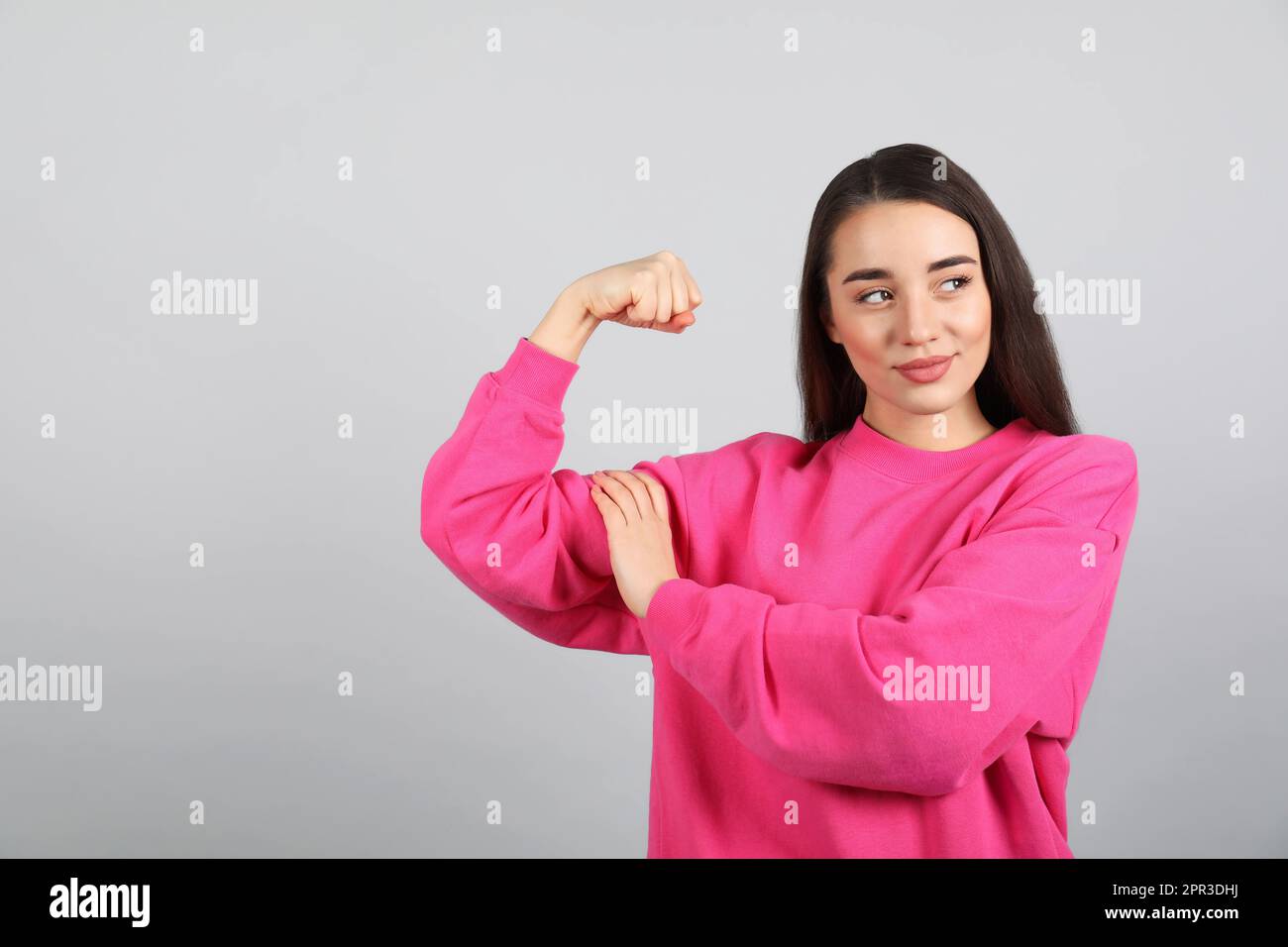 Strong woman as symbol of girl power on light grey background. 8 March ...
