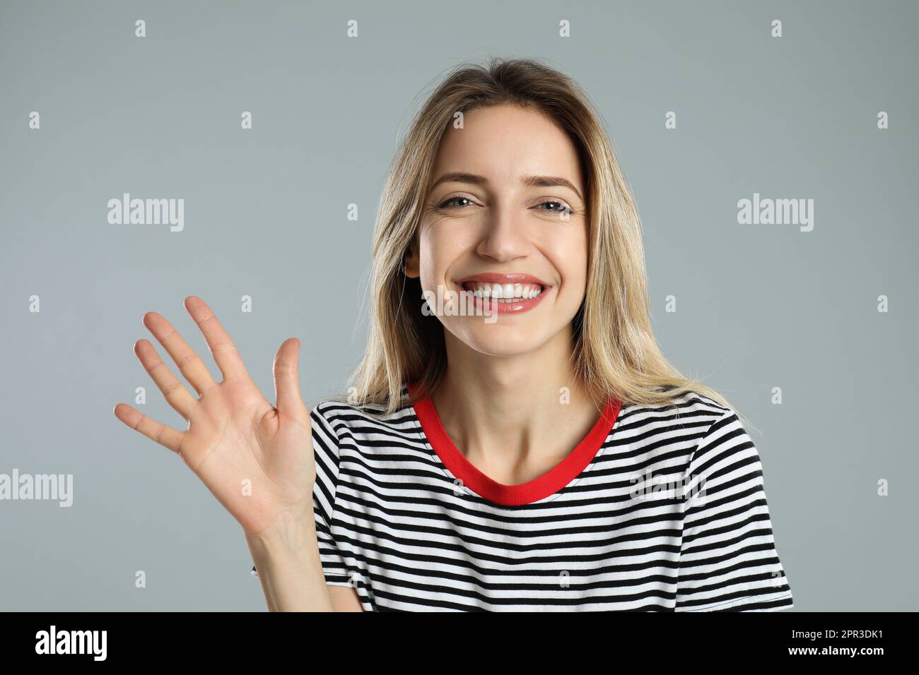 Woman showing number five with her hand on light grey background Stock ...