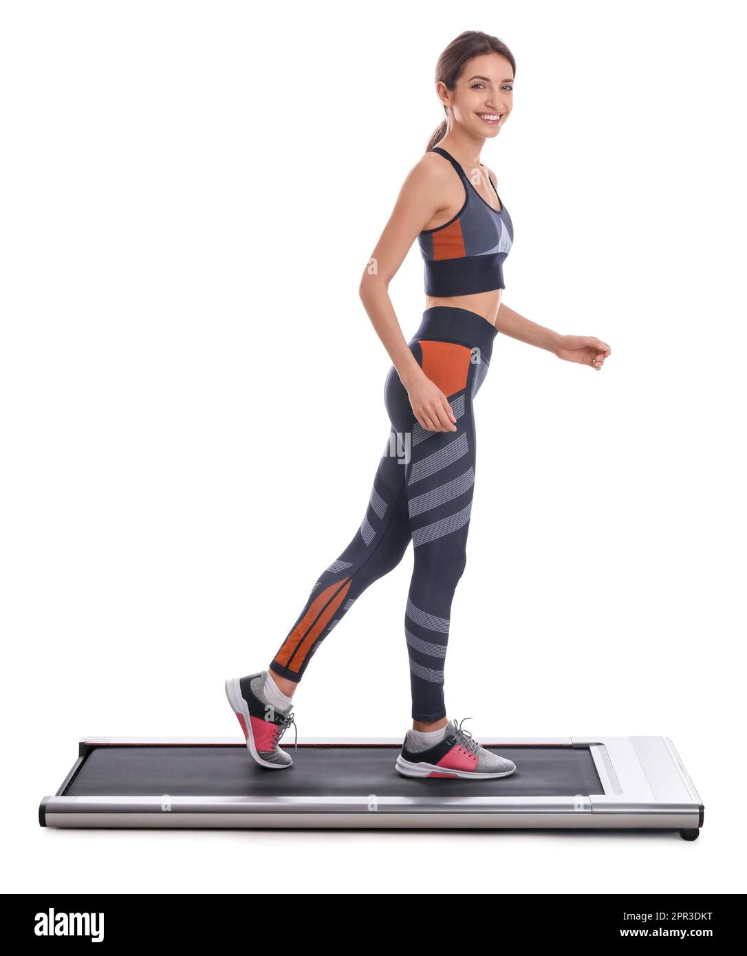 Sporty woman using walking treadmill on white background Stock Photo ...