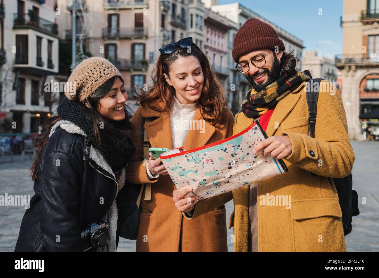 Group of tourists reading a map to found the location of a european ...