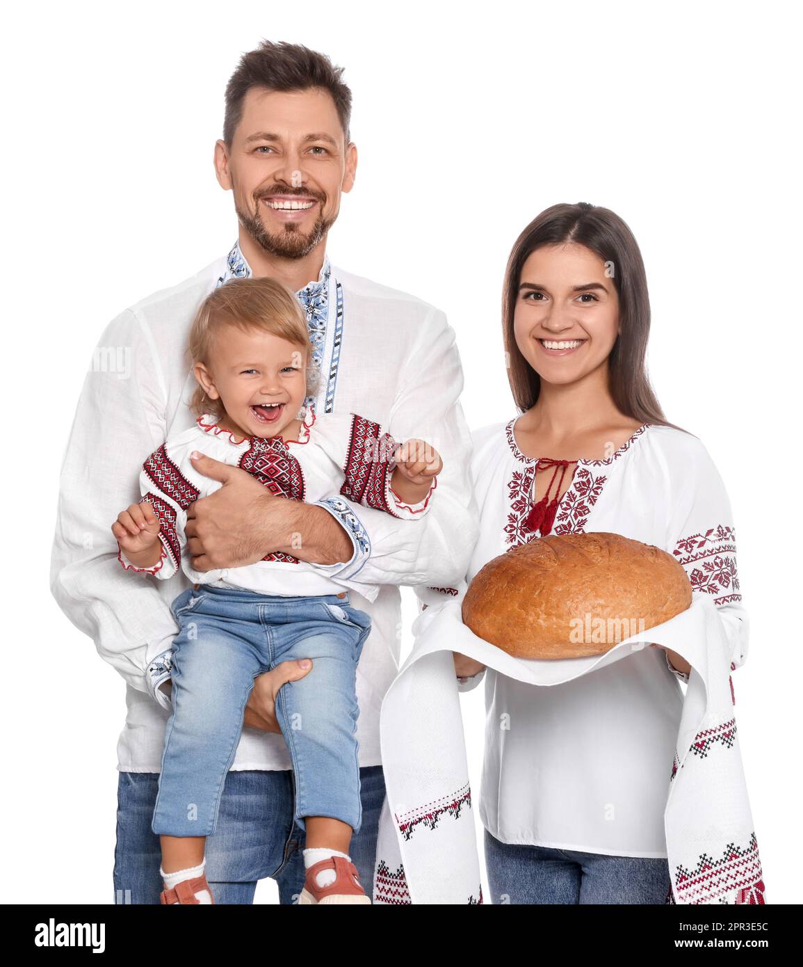 Happy Ukrainian family in embroidered shirts with korovai bread on ...