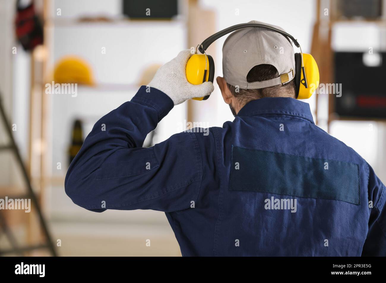 Worker Wearing Safety Headphones Indoors Back View Hearing Protection