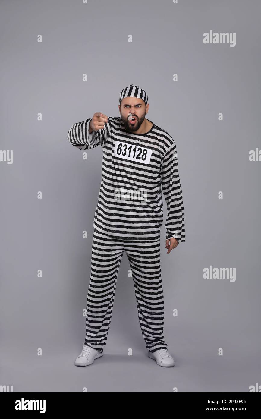 Emotional prisoner in special uniform on grey background Stock Photo ...