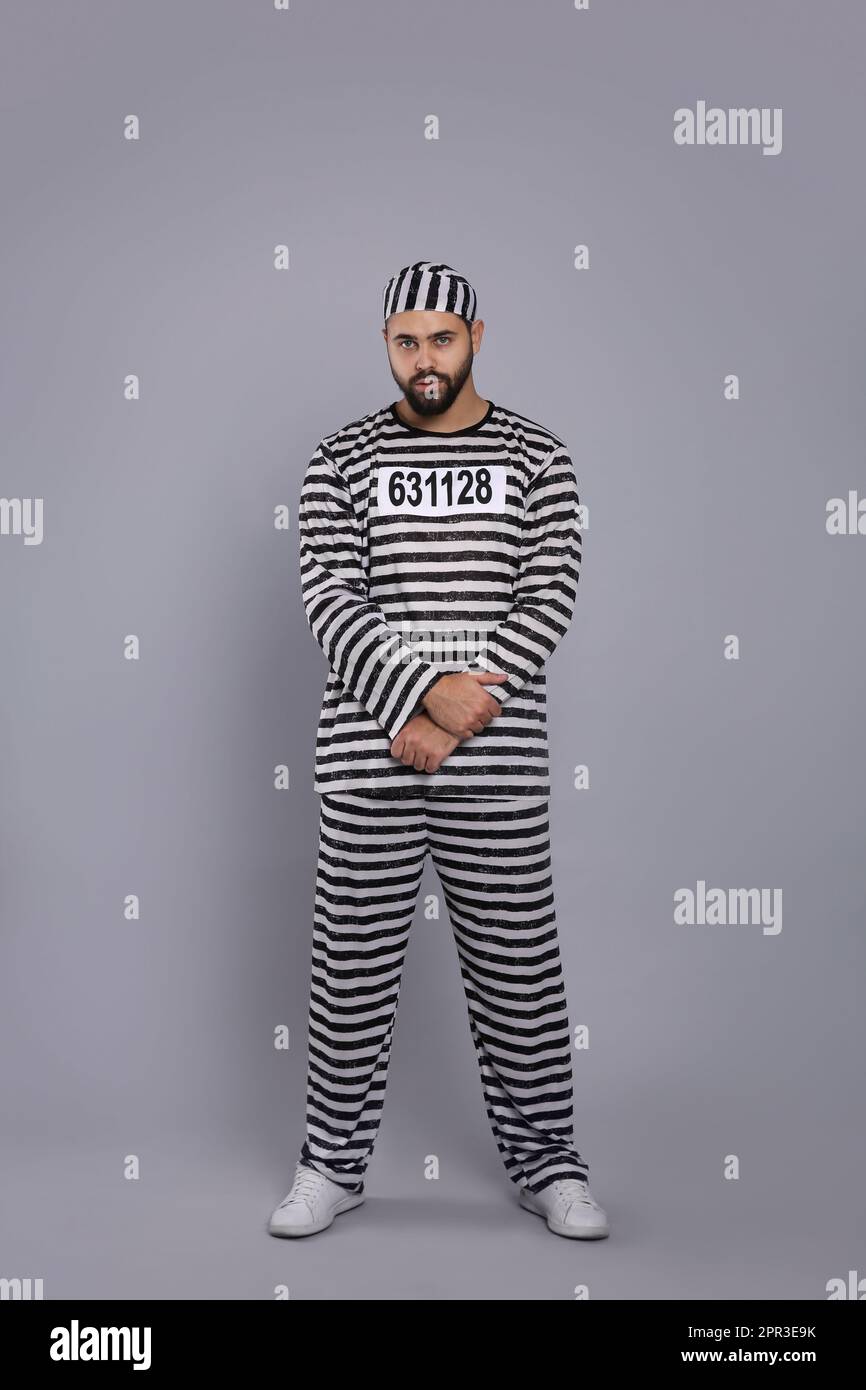 Prisoner in special uniform on grey background Stock Photo - Alamy