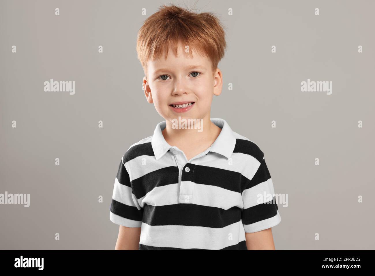 Portrait of cute little boy on light grey background Stock Photo - Alamy