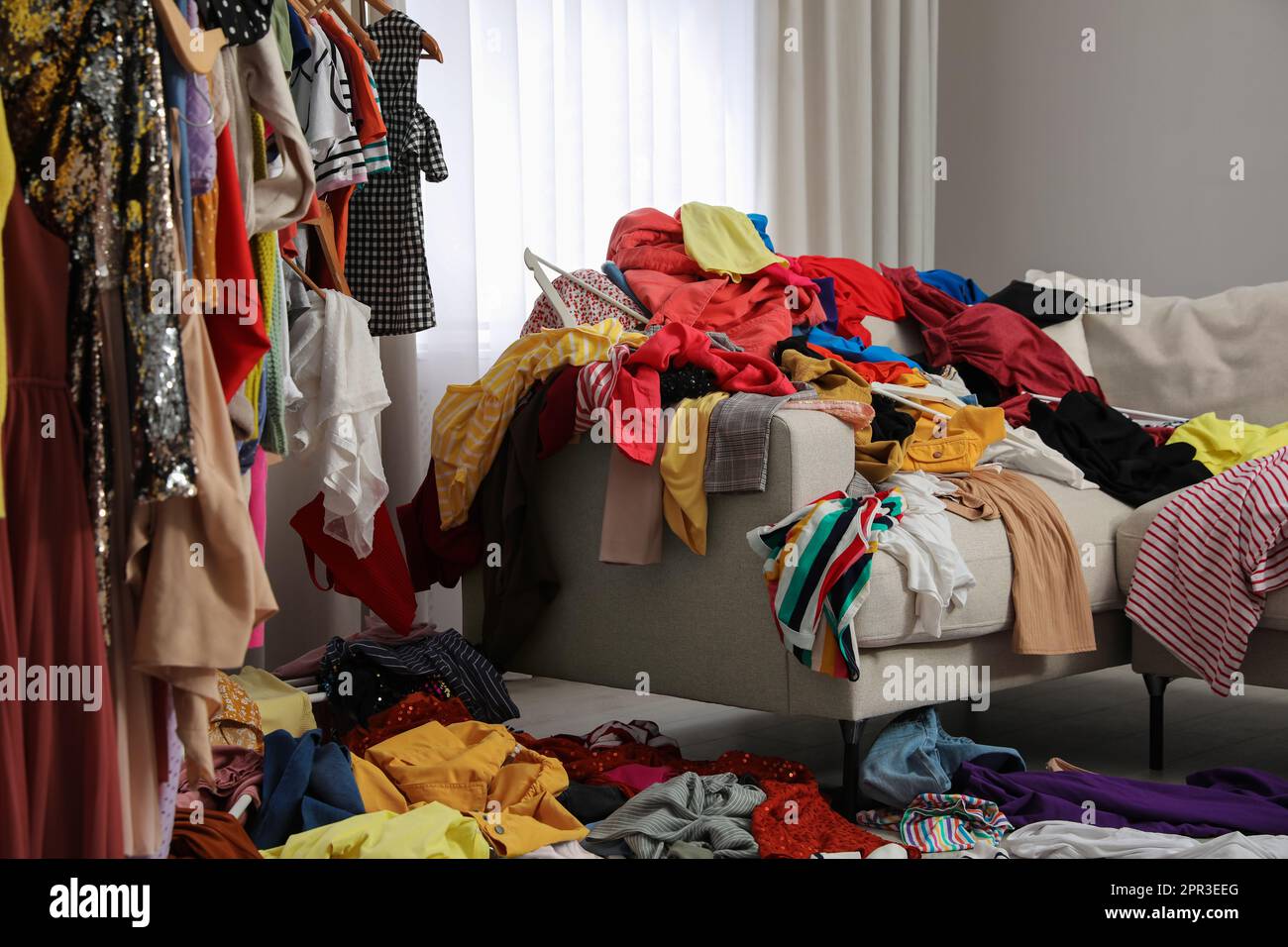 Mess of clothes all over room. Fast fashion Stock Photo - Alamy