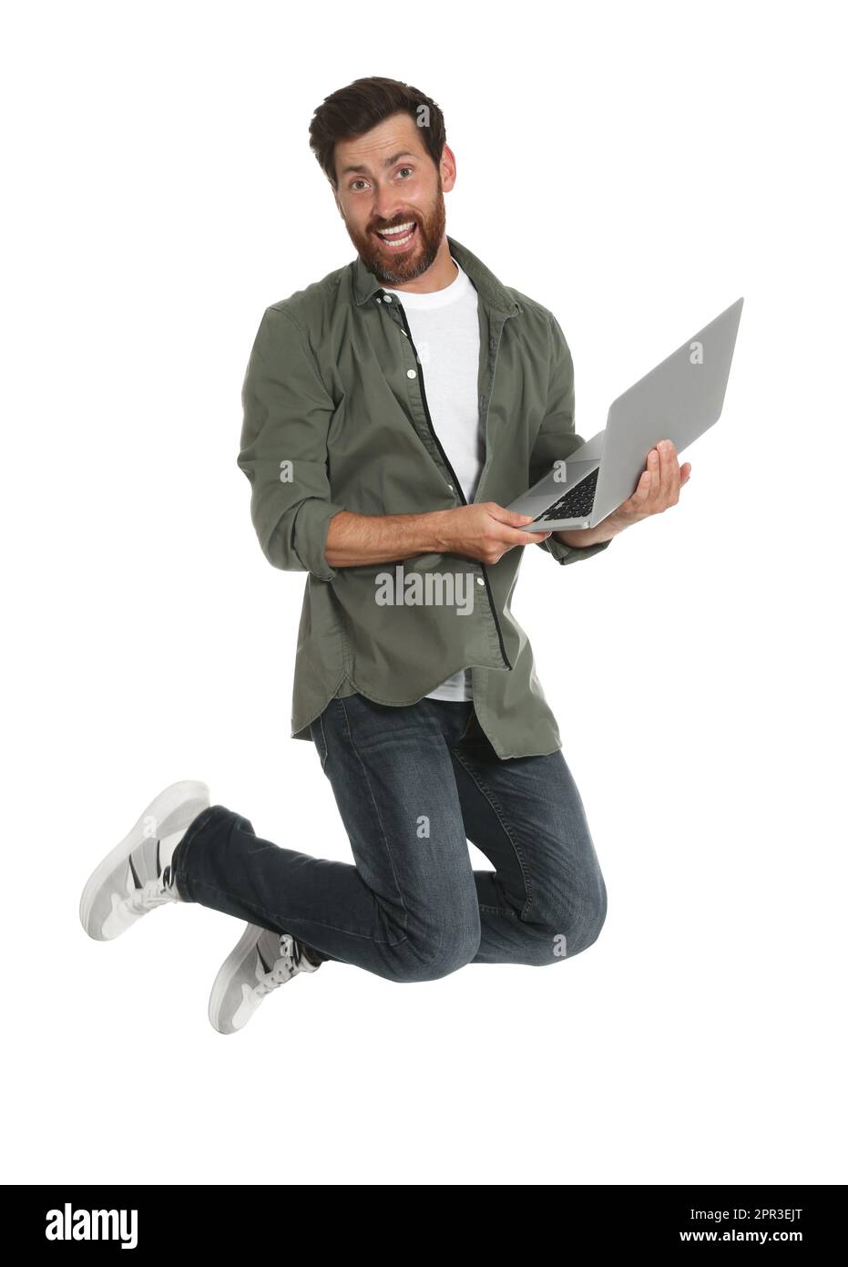 Happy man with laptop jumping on white background Stock Photo - Alamy