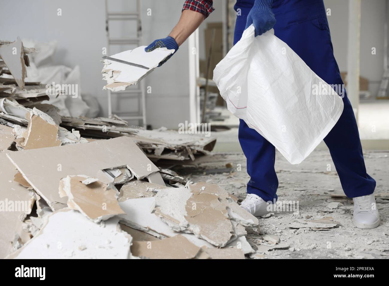 Construction worker with used building materials in room prepared for ...