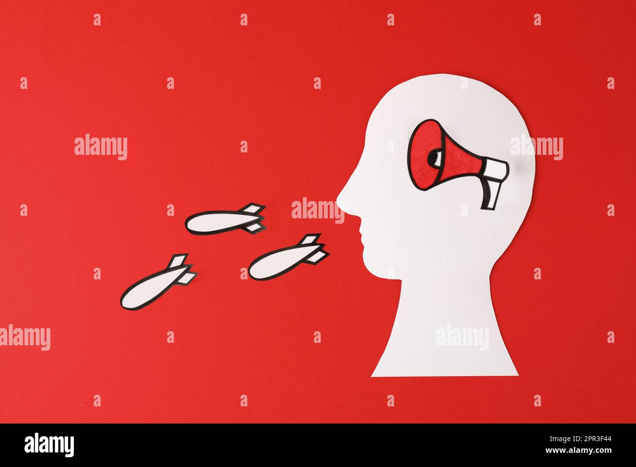 Paper human cutout with megaphone in head and bombs flying out of mouth ...