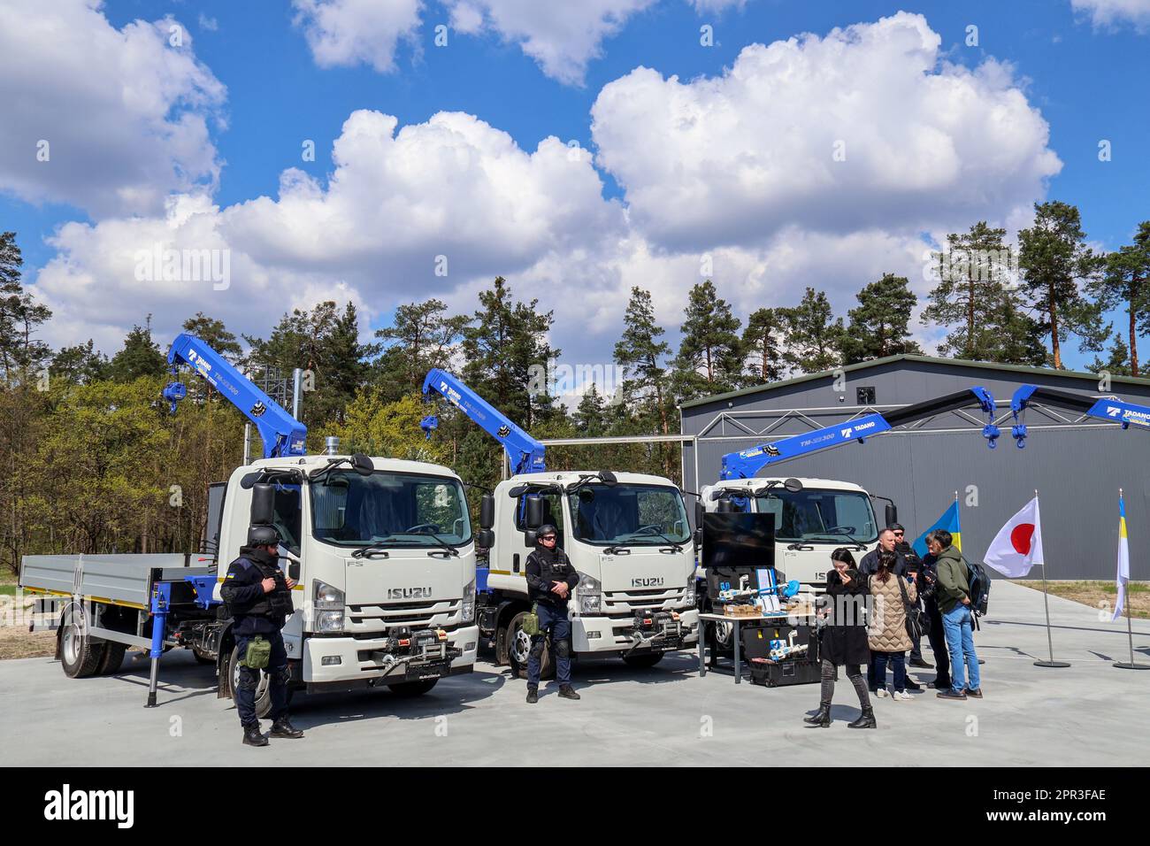KOZYN, UKRAINE - APRIL 25, 2023 - Rescuers stand by trucks equipped ...