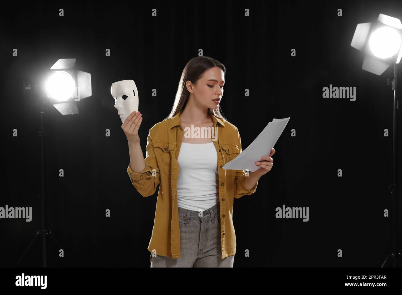 Professional actress reading her script during rehearsal in theatre ...