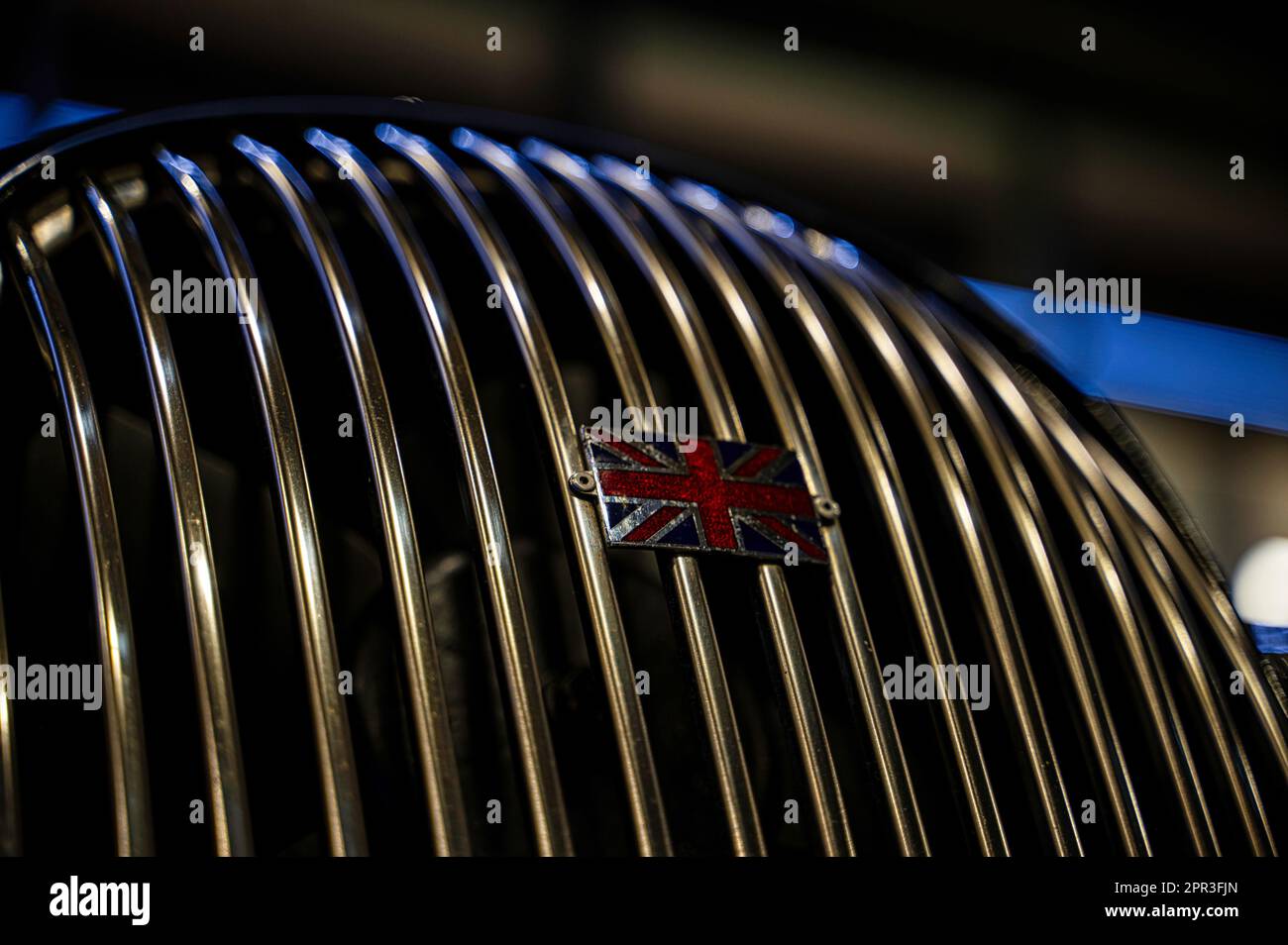 A close-up shot of a classic car with a Union Jack sign on its front ...
