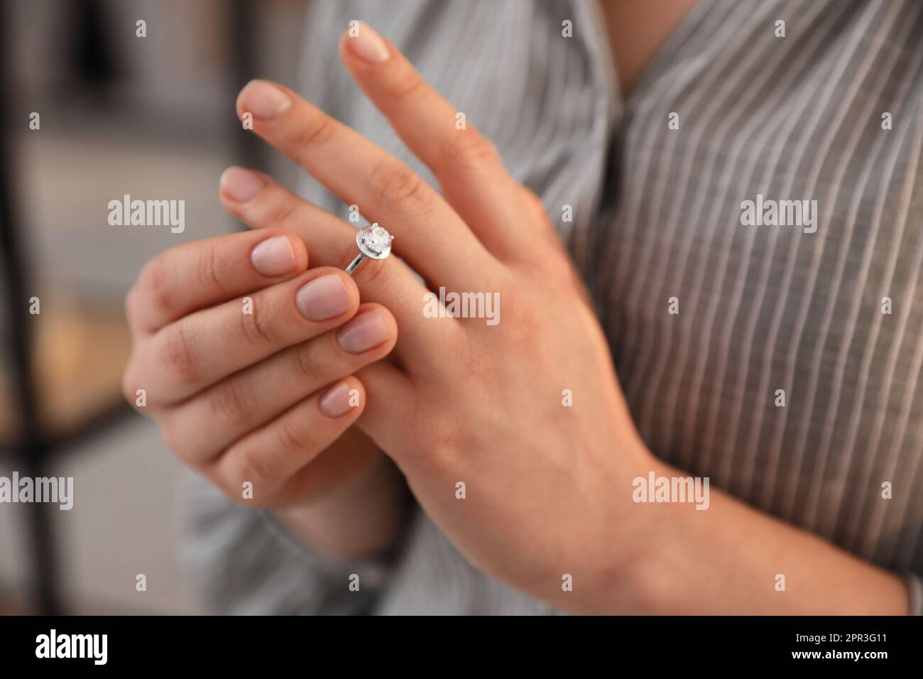 Woman taking off wedding ring indoors, closeup. Divorce concept Stock ...