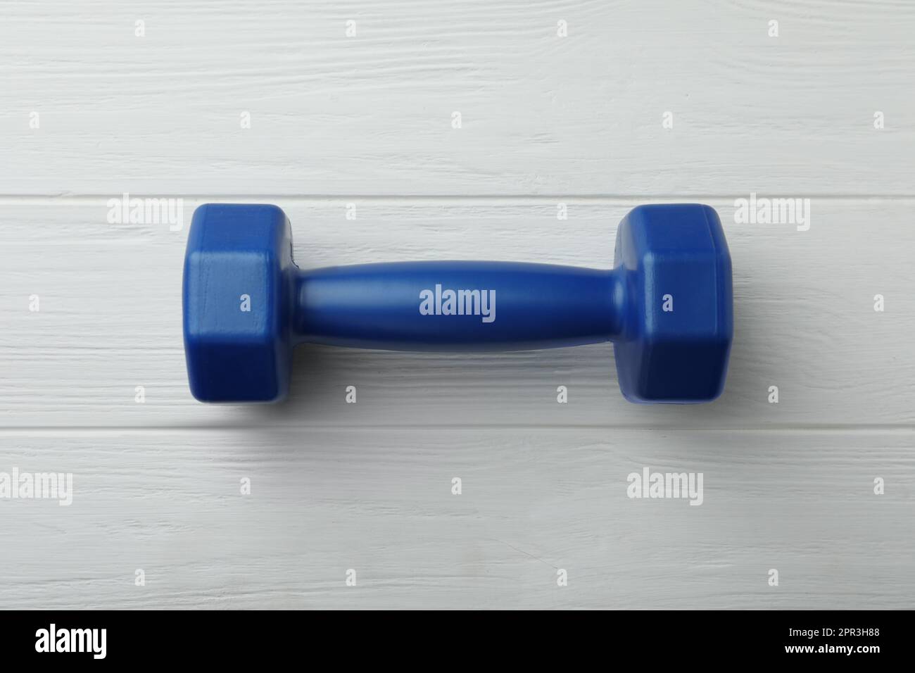 One blue dumbbell on white wooden table, top view Stock Photo - Alamy