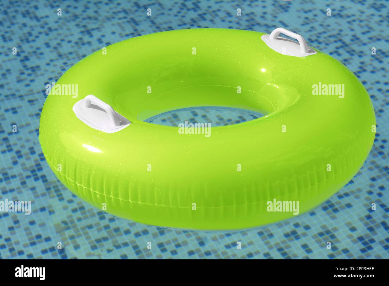 Light green inflatable ring floating in swimming pool Stock Photo - Alamy